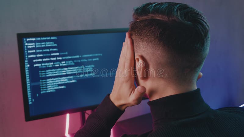 Back View Of Developer Having Stress In The Office Man Programmer Has A Headache At Office Work