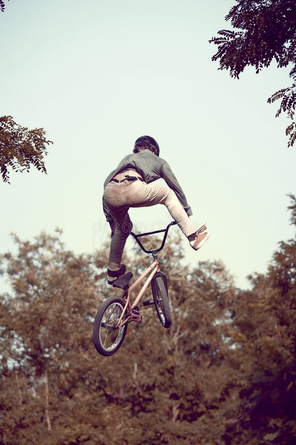Back View Dynamic Image of Young Man in Helmet Riding Bmx Bike in ...