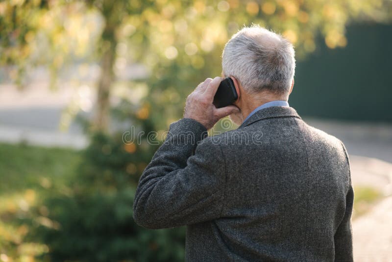 Back View of Elderly Man Speak by the Mobile Phone Outside Stock Image ...