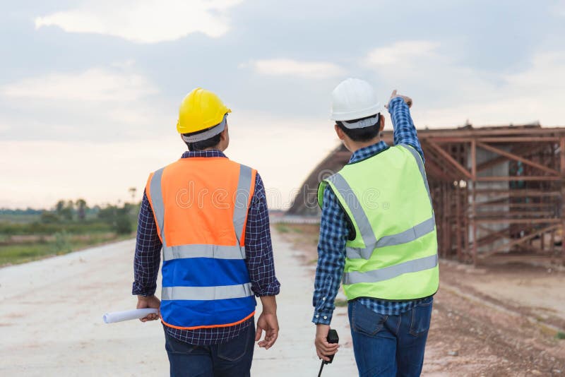 Back View of Engineer and Foreman Worker Checking Project at Building ...