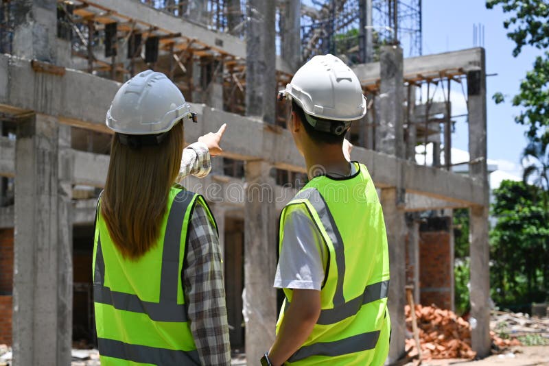 Back View Engineer Team Wearing Yellow Vests Discussing the ...