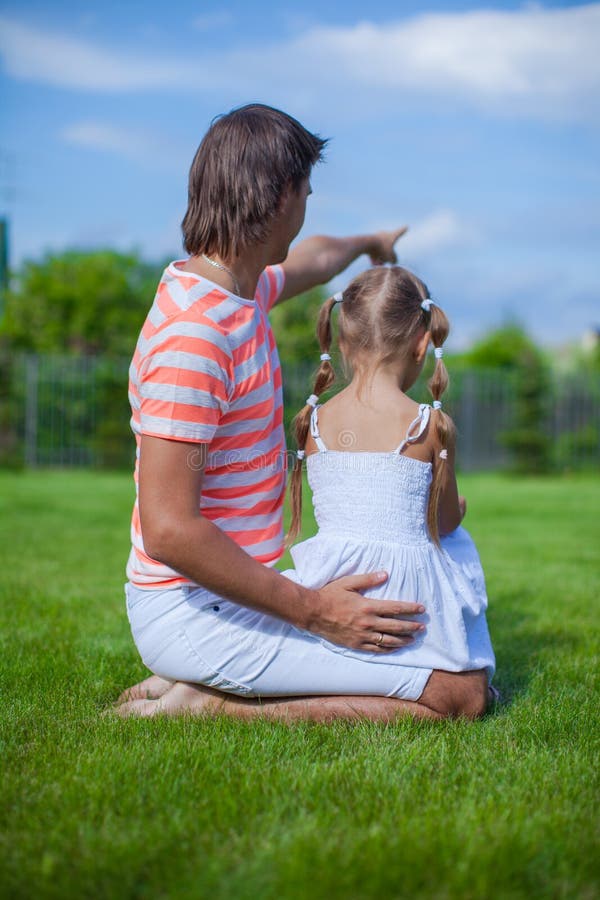 Back View of Father with His Daughter Sitting in Stock Photo - Image of ...