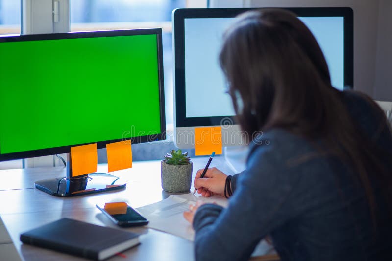 Back View of a Female Architect Drawing and Working on Her New Project ...