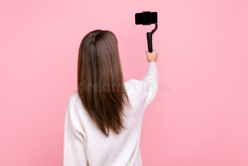 Back View of Female Broadcasting Livestream, Using Steadicam and Phone ...