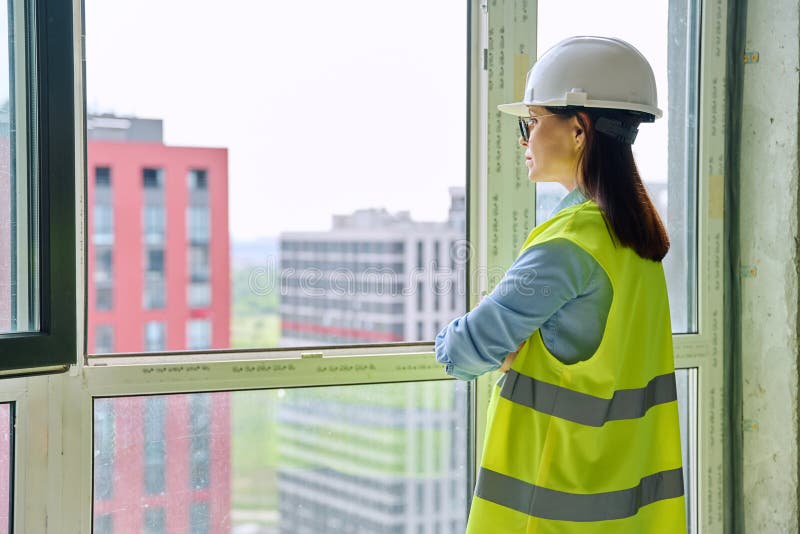 Back View of Female Industrial Worker in Protective Helmet Vest Looking ...