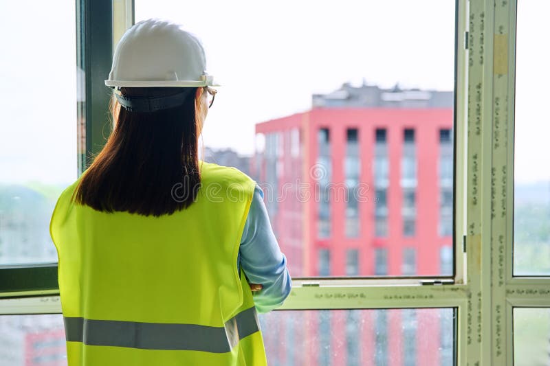 Back View of Female Industrial Worker in Protective Helmet Vest Looking ...