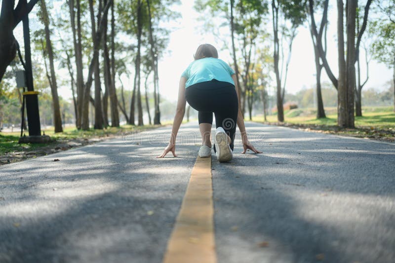 Back View of Female Runner Standing in Start Position on Street ...