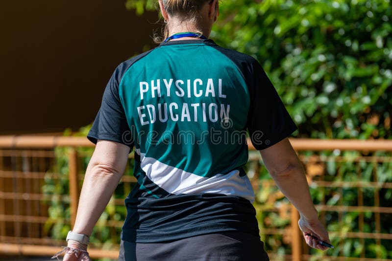 Back View Of Female Swimming Coach Wearing Physical Education Shirt