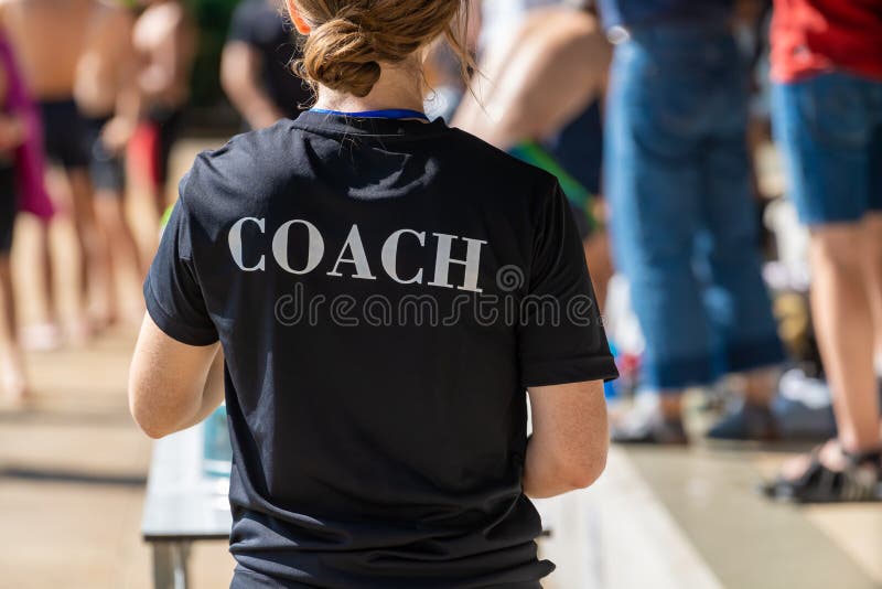 Back View Of Female Swimming Coach Wearing Coach Shirt Stock Image