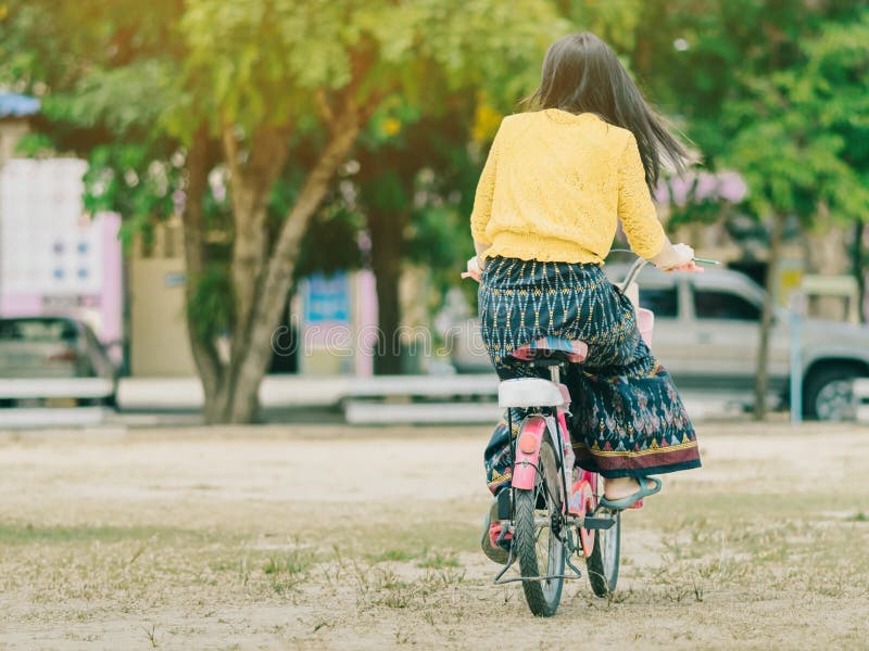 Back View of Female Teacher Rides Bicycle To Teach Students Editorial ...