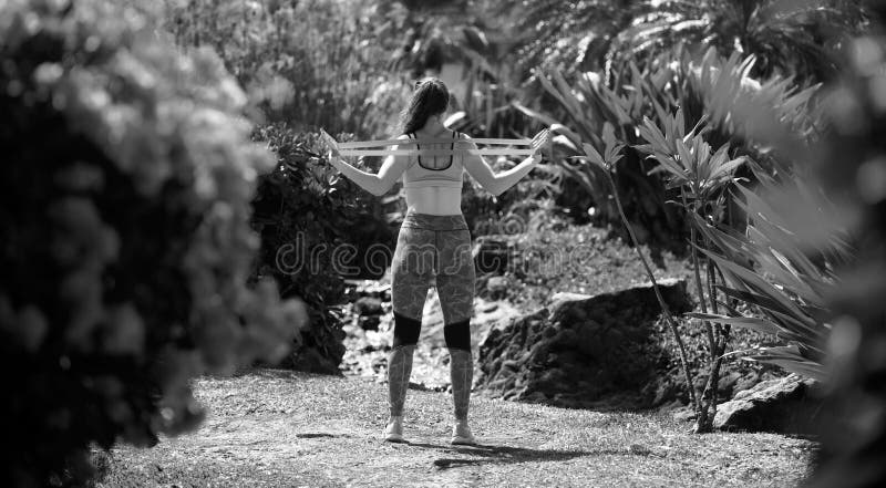 Back View of Fit Woman Training with Resistance Band Outdoors. Stock ...