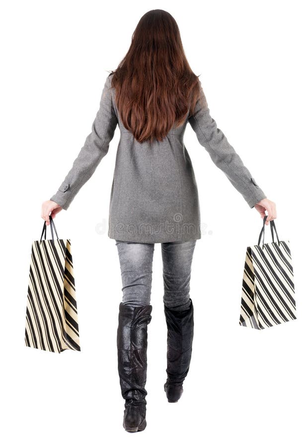 Back View of Going Woman in Jacket with Shopping Bags Stock Image ...