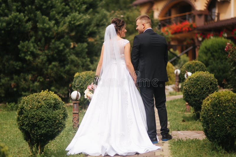 Back View of Groom and Bride. Couple Walks in the Park Stock Image ...