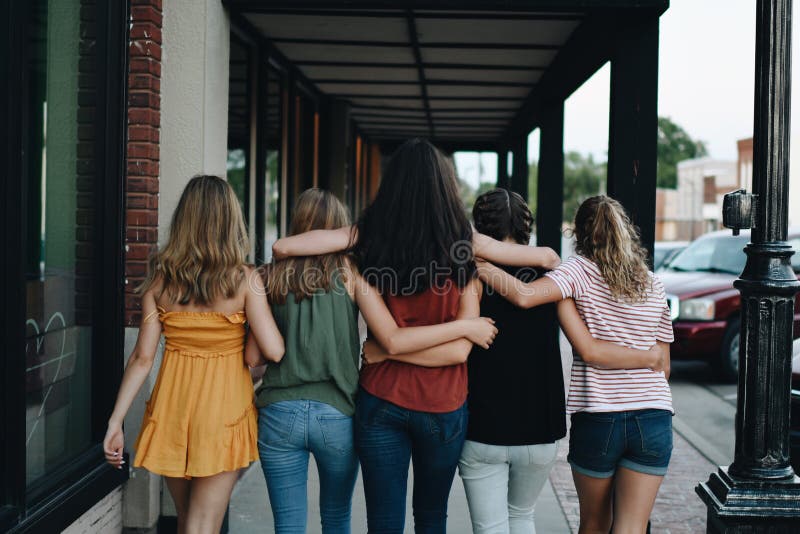 Back View of a Group of Female Friends Hugging and Walking Outdoors ...
