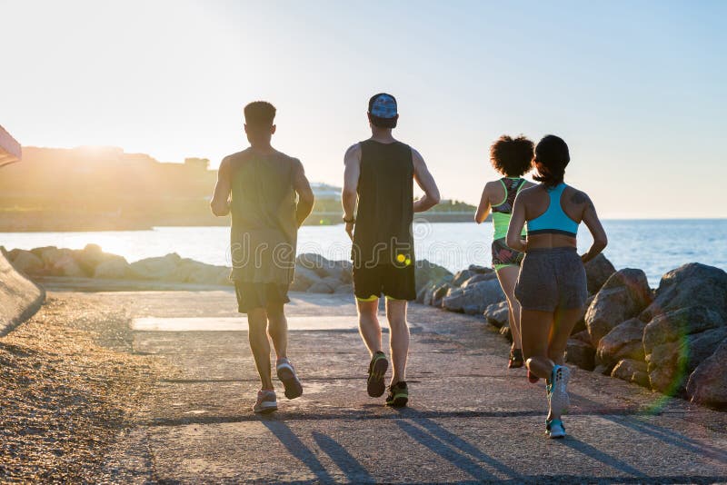 Back View of a Group of Young Sporty Friends Jogging Stock Photo ...