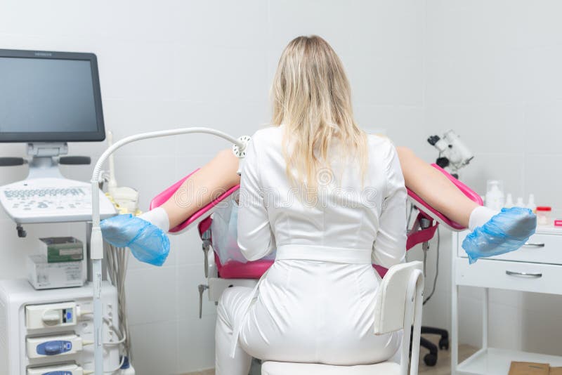 Back View Of A Gynecologist Conducting A Routine Examination Of A Girl