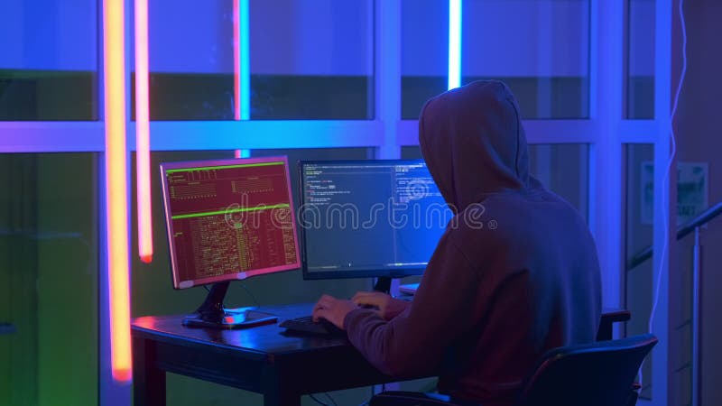 Back View of Hacker Dressed in a Dark Close Working on Computer Stock ...