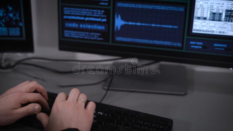 Back View of a Hacker Sitting and Making Cyber Attack on Network. Man ...