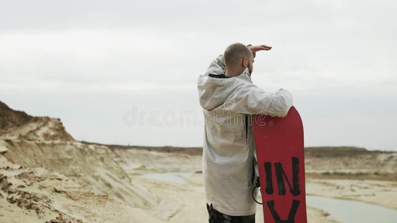 Back View of Handsome Bald Man Posing with Sandboard in Desert or Sand ...