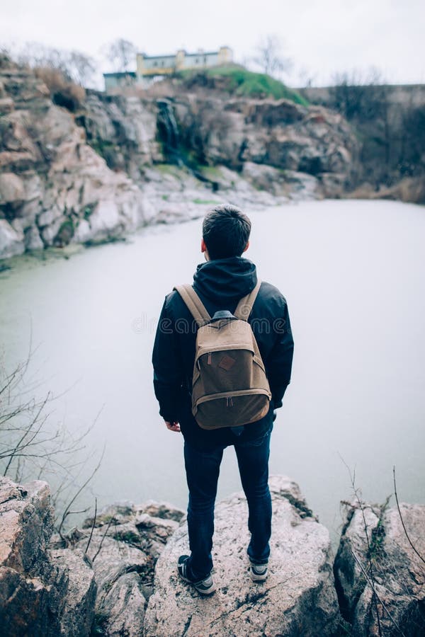 Back View of Handsome Man Standing on Rocky Cliff Stock Image - Image ...