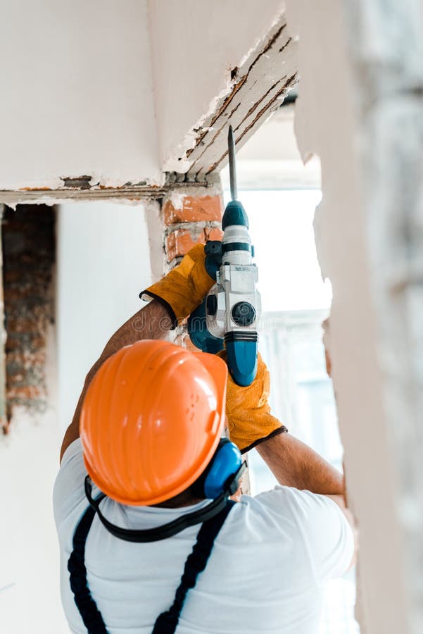 View of Handyman Using Hammer Drill on Wall Stock Photo - Image of ...