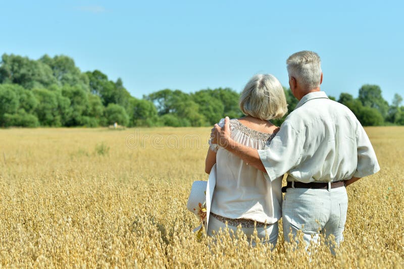 Back View. Happy Elderly Couple Resting in Field Stock Image - Image of ...