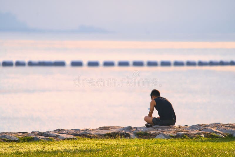 Back View of Human Sitting on Rock Near Lake Stock Photo - Image of ...