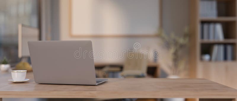 Back View Image of a Laptop Computer on a Wooden Table in a Modern ...