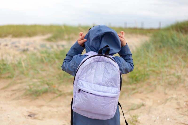 Back View of a Kid with a Backpack Standing on the Beach Stock Photo ...