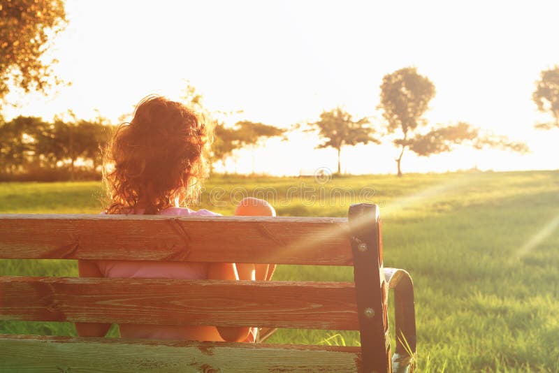 Back View of Kid Sitting on the Bench at Sunset in the Park Stock Image ...
