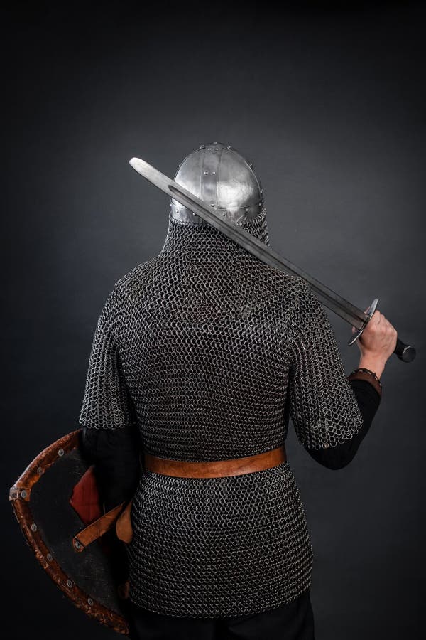 Back View of a Knight in Chain Mail and a Helmet with a Sword on His ...
