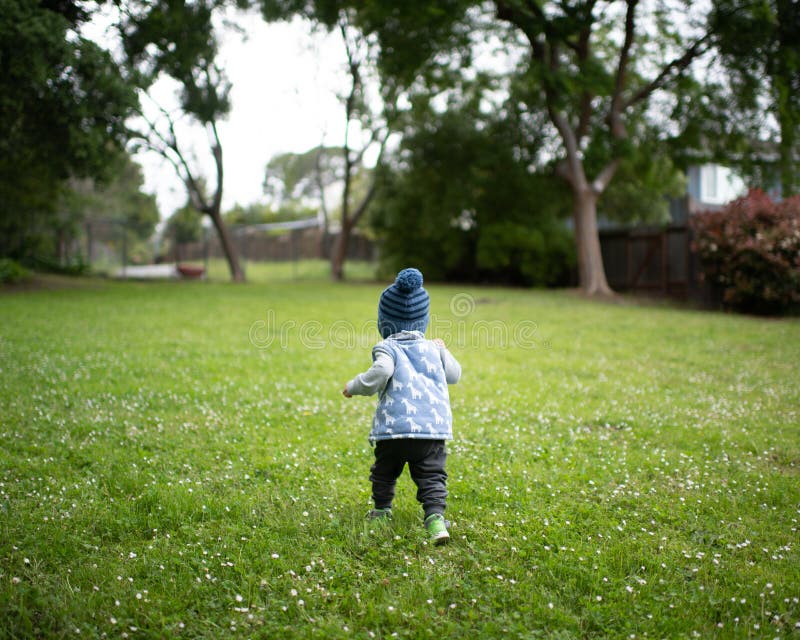 Back View of a Little Boy Running in the Green Park Stock Photo - Image ...