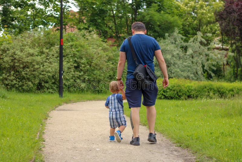 Back View of a Loving Father Walking in the Park with His Toddler Son ...