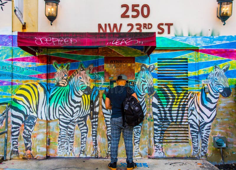 Back View of a Male in Front of an ATM Machine with Graffiti Art ...