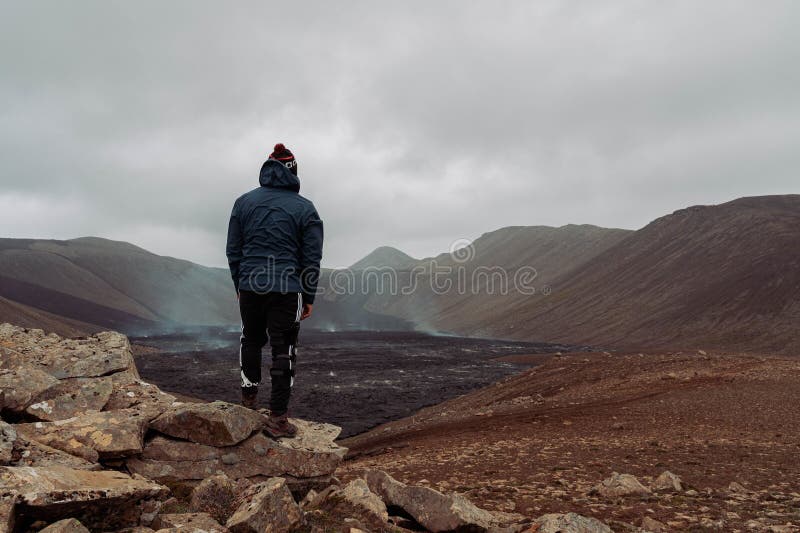 Back View of Male Standing on Rock in Volcano Field Stock Image - Image ...