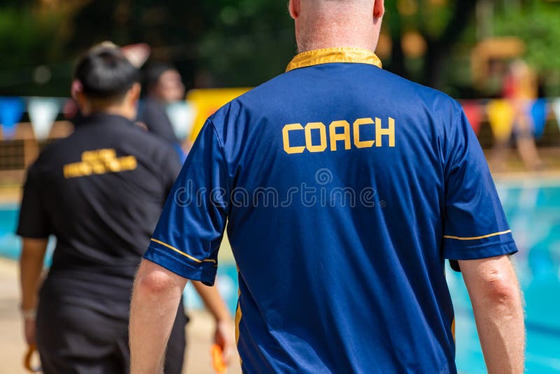 Back View Of Female Swimming Coach Wearing Physical Education Shirt
