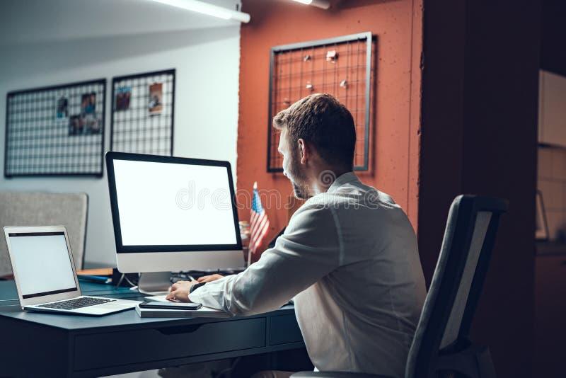 Smiling Young Man is Typing on Computer Stock Image - Image of ...