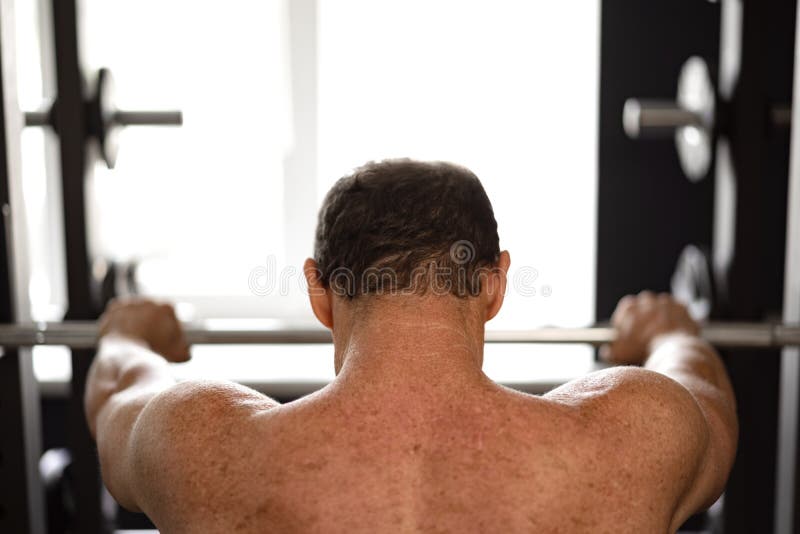 Back View of a Man Bodybuilder Exercising in a Gym Stock Image - Image ...
