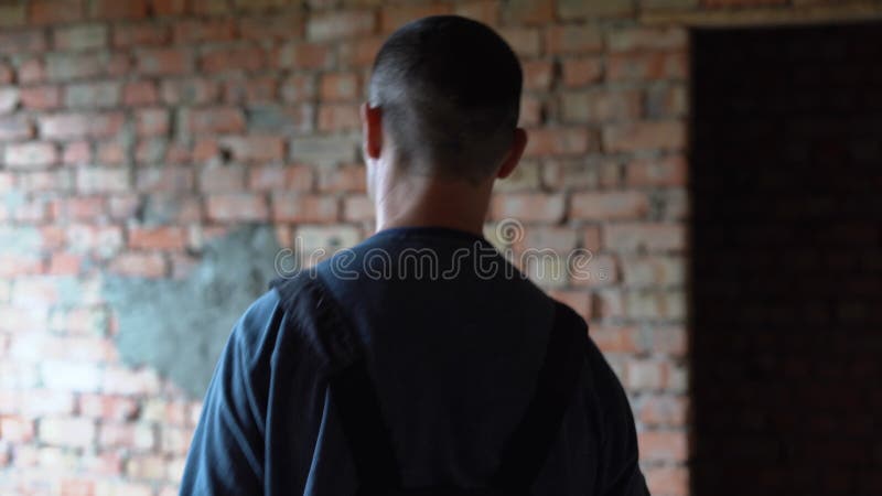 Back View a Man Builder Dressed in a Uniform Walks Along a Construction ...