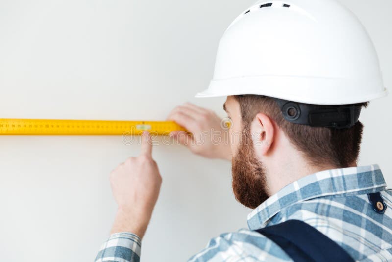 Back View of Man Builder Using Ruler To Measure Length Stock Image ...