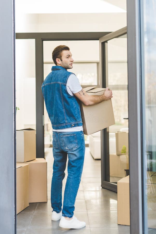Back View of Man with Cardboard Box Moving Stock Image - Image of jeans ...
