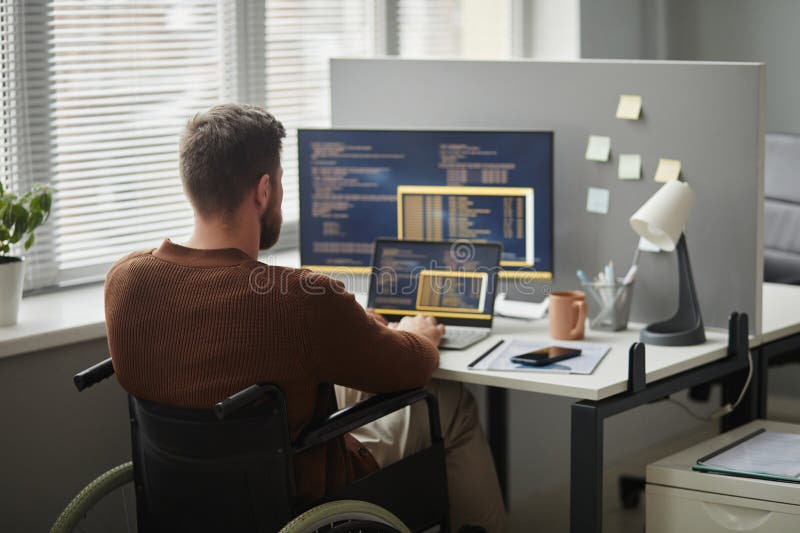 Back View Man with Disability As it Professional Using Computer Stock ...