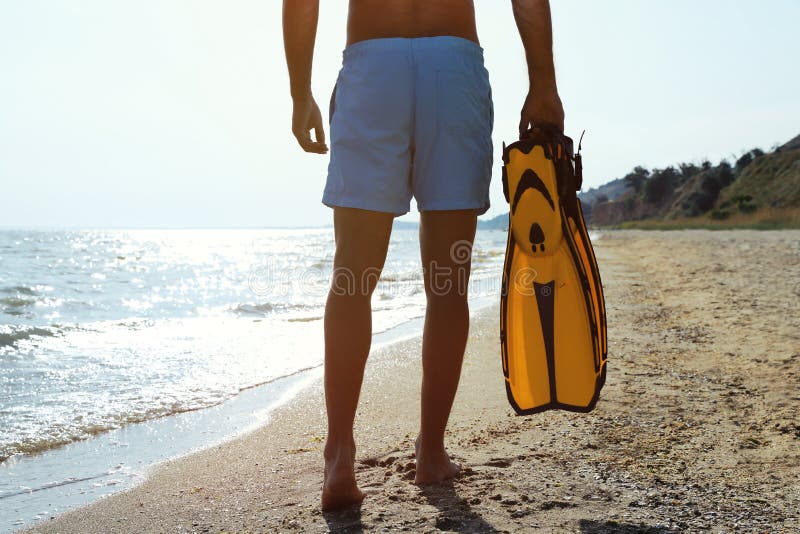 Back View of Man with Flippers Walking on Beach, Closeup Stock Image ...