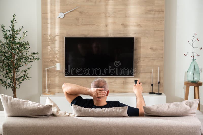 Back View of Man in Front of TV in Modern Living Room Stock Photo ...