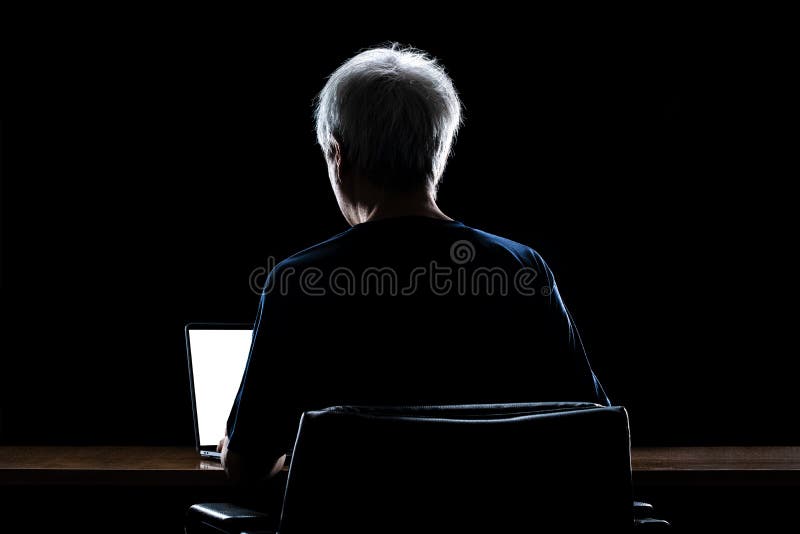 Back View of a Man with Gray Hair Working from Home Late at Night Using ...