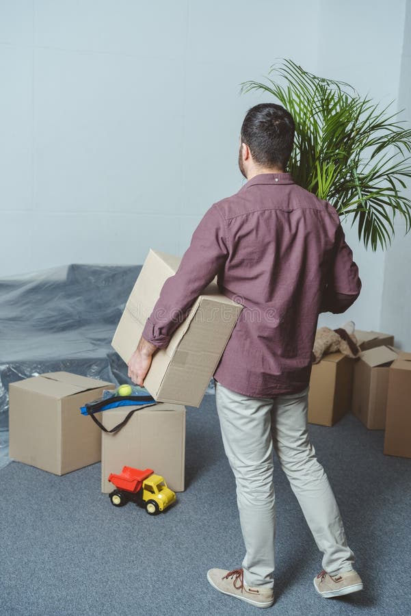 Back View of Man Holding Cardboard Box while Moving Stock Image - Image ...