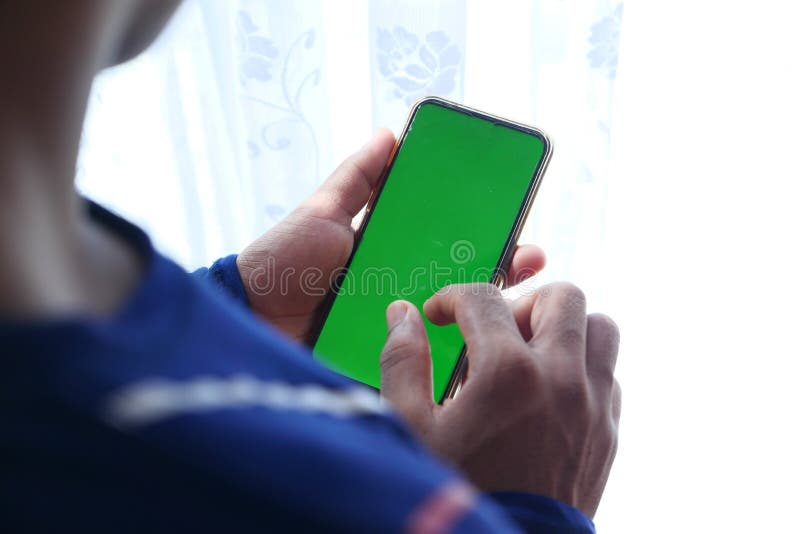 Back View of Man Holding Smart Phone with Green Screen Stock Image ...