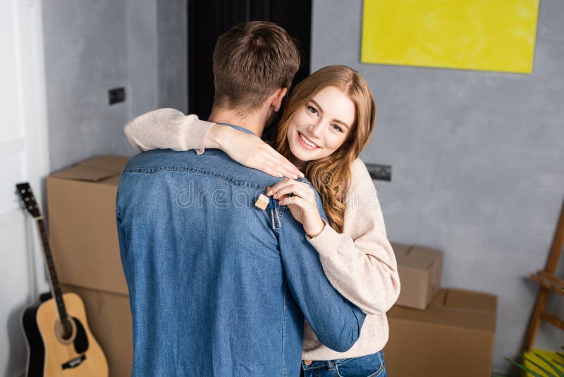 Back View of Man Hugging Woman Stock Photo - Image of couple, boxes ...