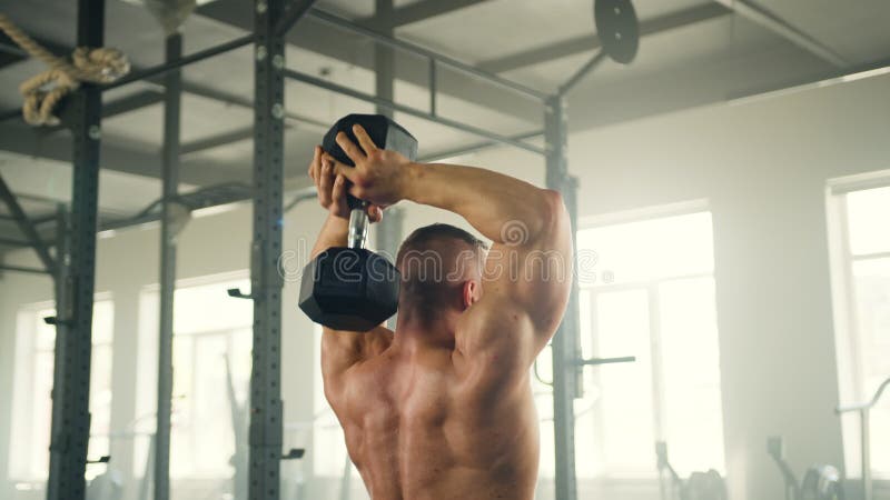 Back View of Man with Muscular Bare Torso Doing Overhead Tricep ...