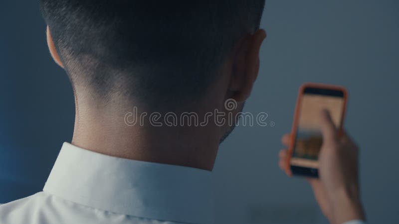 Back View Man at Office Using Smartphone, Doing Swiping, Scrolling ...